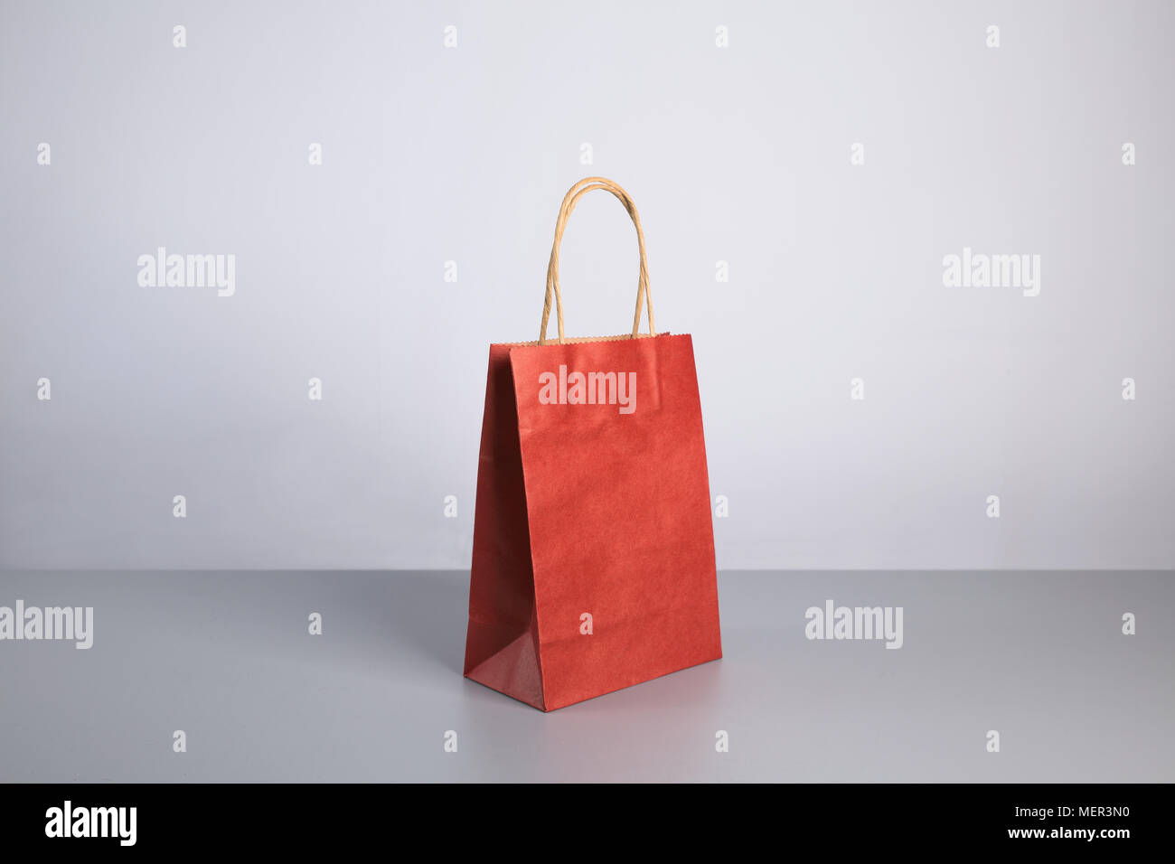 red color paper bag on table Stock Photo - Alamy