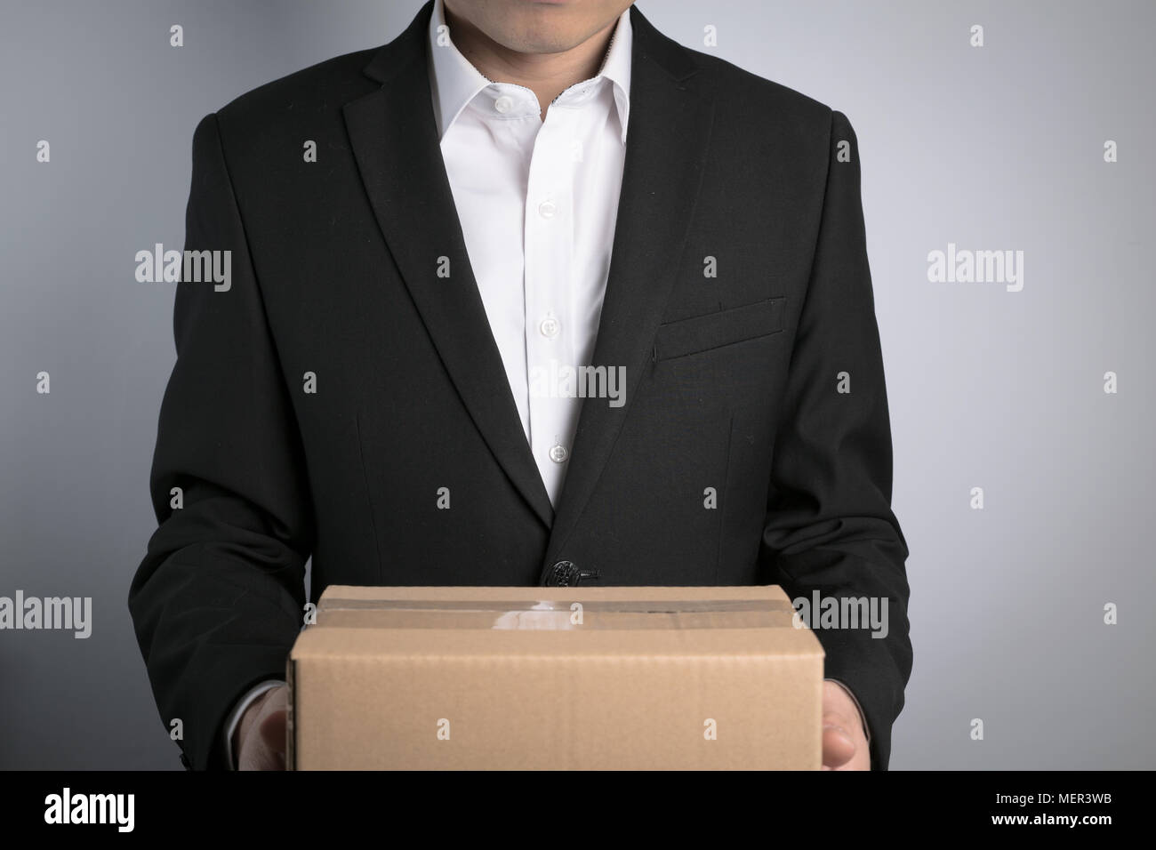 business man holding a box Stock Photo - Alamy