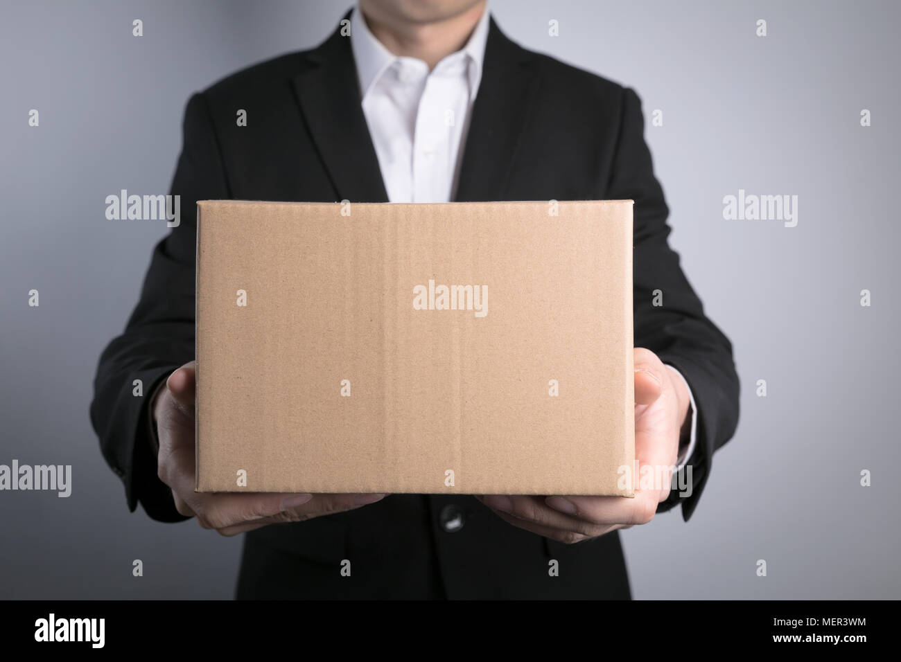 business man holding a box Stock Photo - Alamy