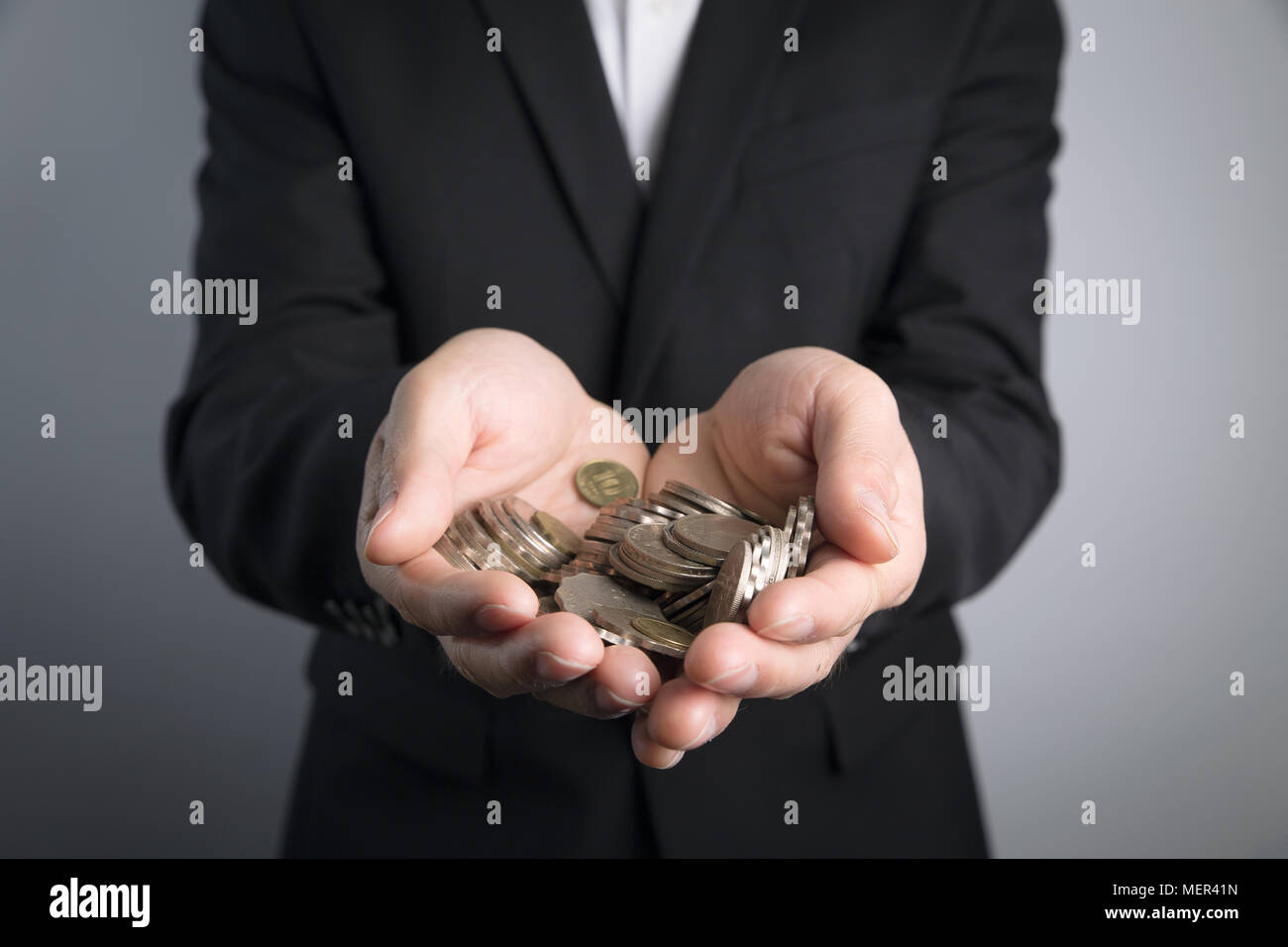 Man holding coins hi-res stock photography and images - Alamy