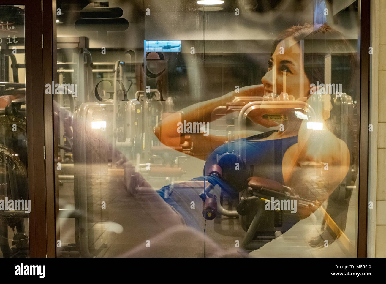 Reflection of a women on the Gym glass showing fitness Stock Photo - Alamy