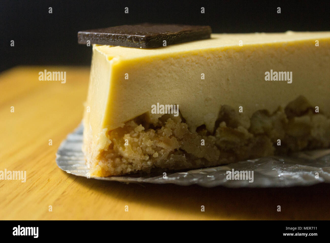 Piece of cheesecake on wood table and dark background Stock Photo - Alamy