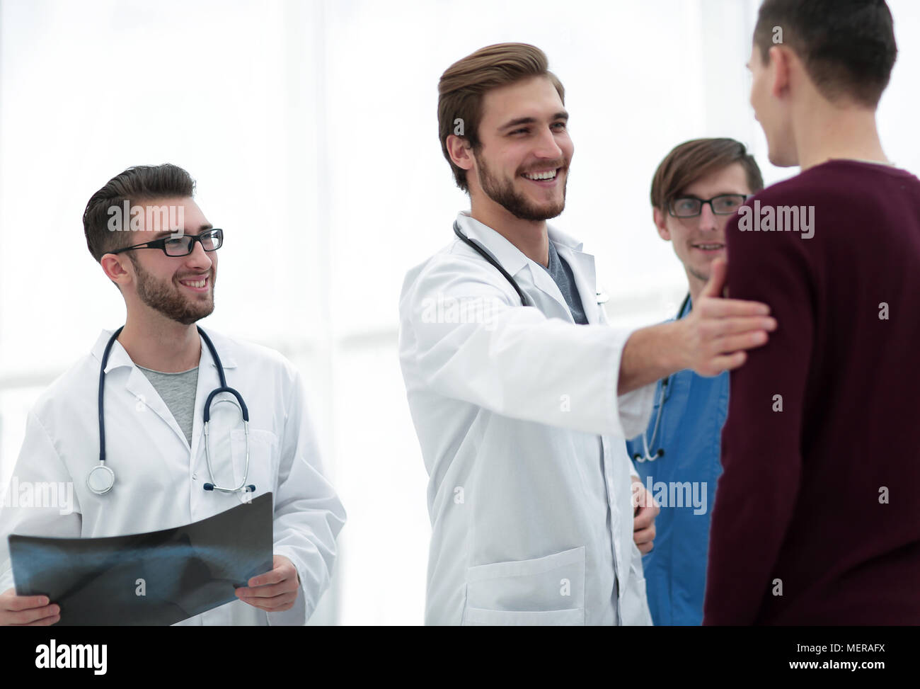 handsome doctor talking with the patient Stock Photo - Alamy