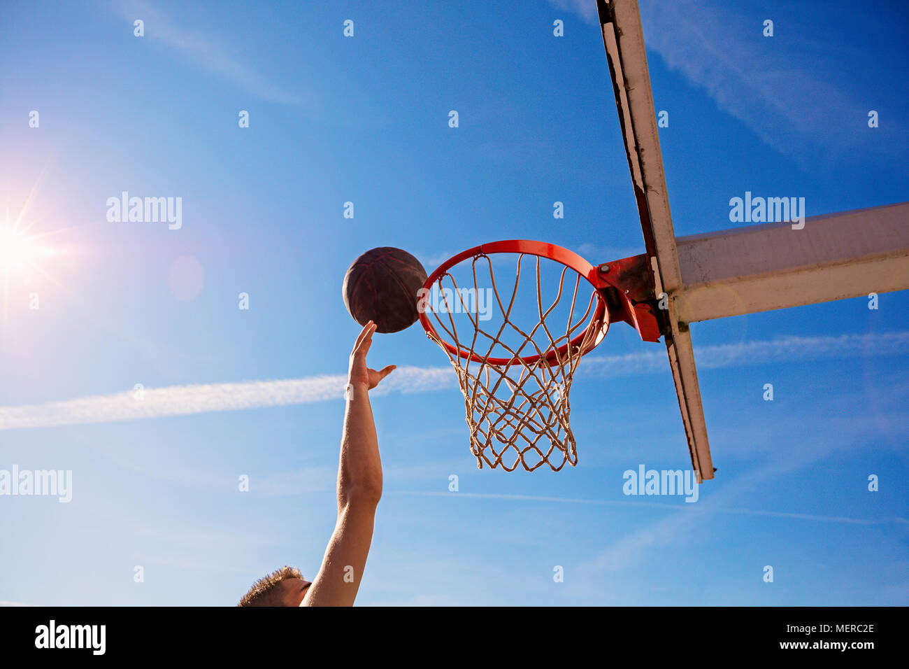 Slam Dunk. Side view of young basketball player making slam dunk Stock ...
