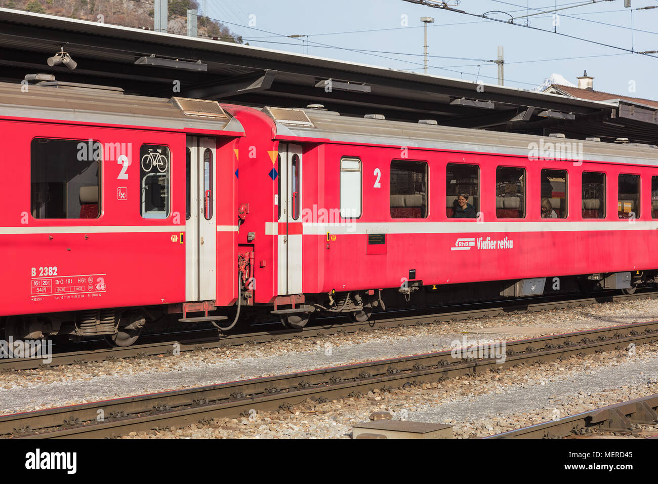 Railroad cars of a train of the Rhaetian Railway at a platform of the ...
