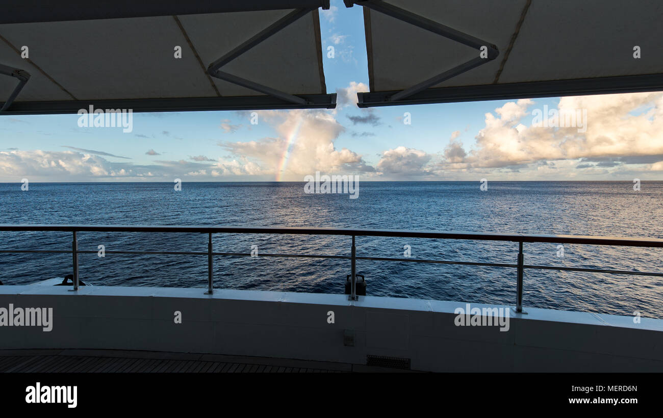 Boat deck view of a rainbow on the open sea Stock Photo - Alamy