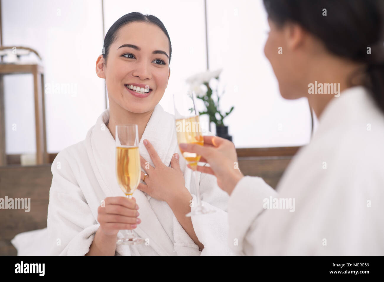 Nice delighted women drinking champagne Stock Photo - Alamy
