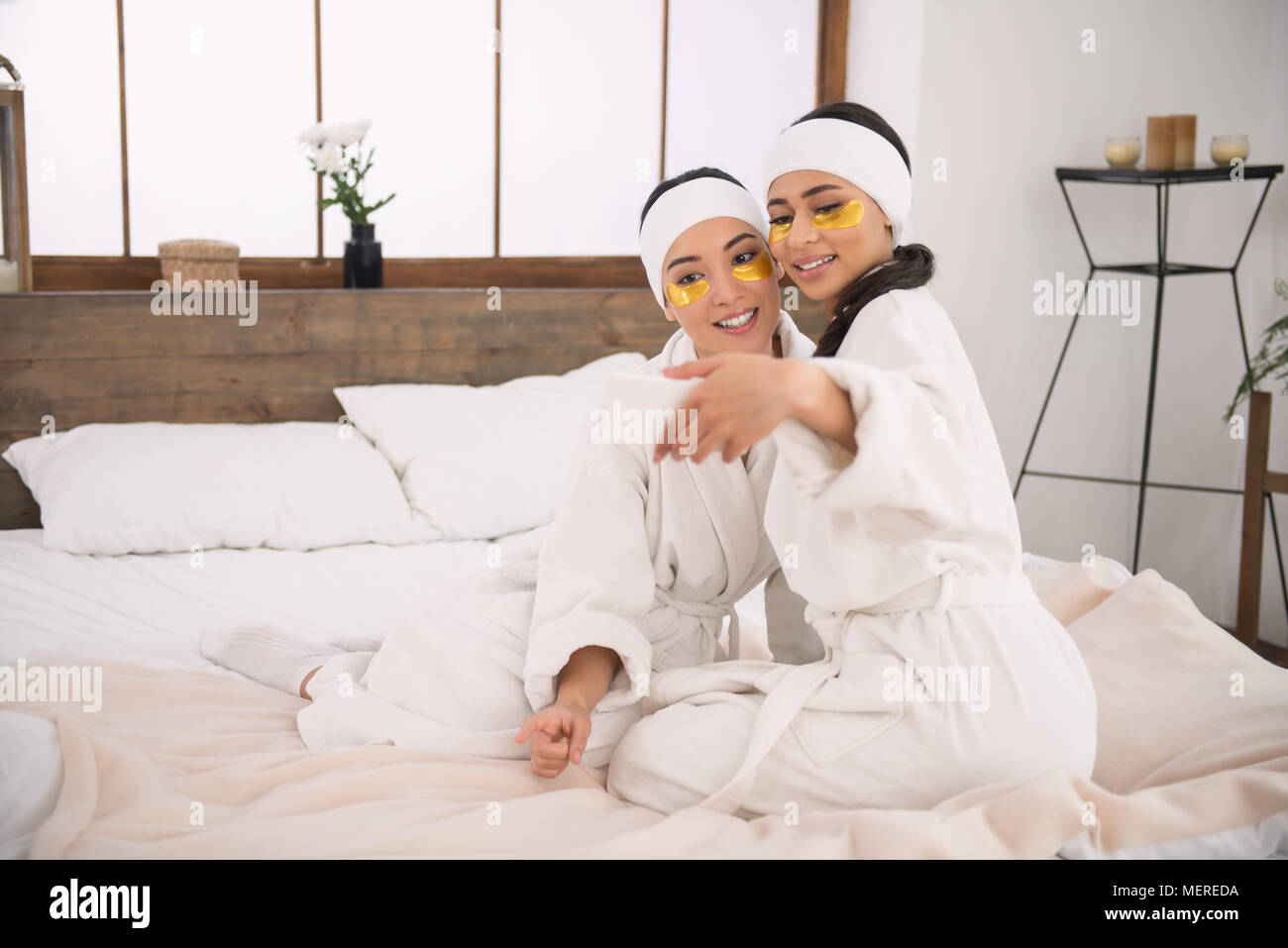 Delighted attractive women having fun in the spa Stock Photo - Alamy