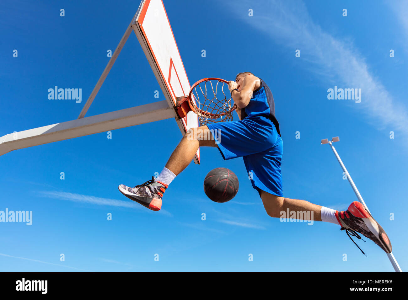 Slam Dunk. Side view of young basketball player making slam dunk Stock ...