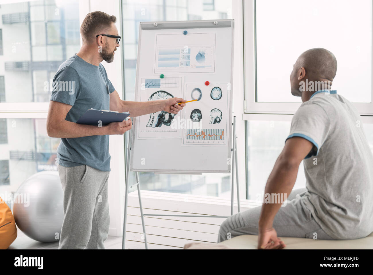 Nice smart doctor showing the picture Stock Photo - Alamy
