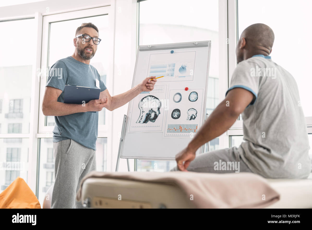 Intelligent professional therapist speaking Stock Photo - Alamy