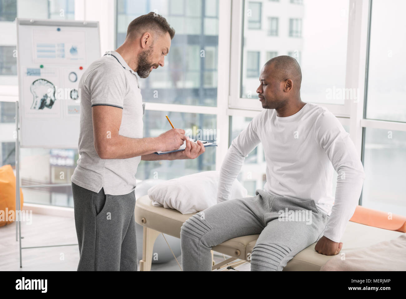 Doctor looking patient notes hi-res stock photography and images - Alamy