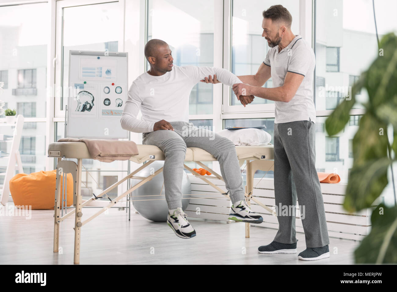 Sad young man looking at his hand Stock Photo - Alamy