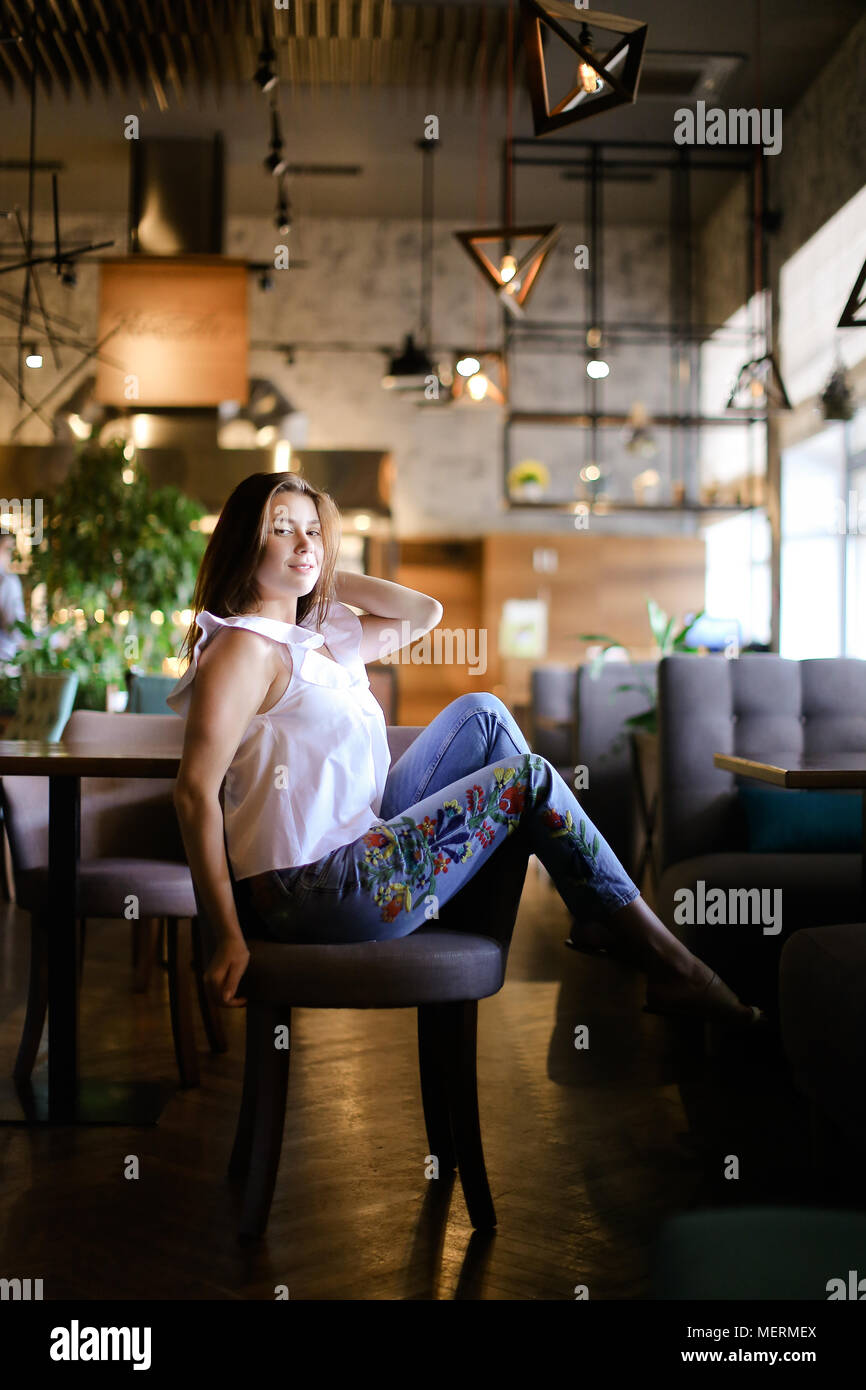 Nice girl sitting on chair hi-res stock photography and images - Alamy