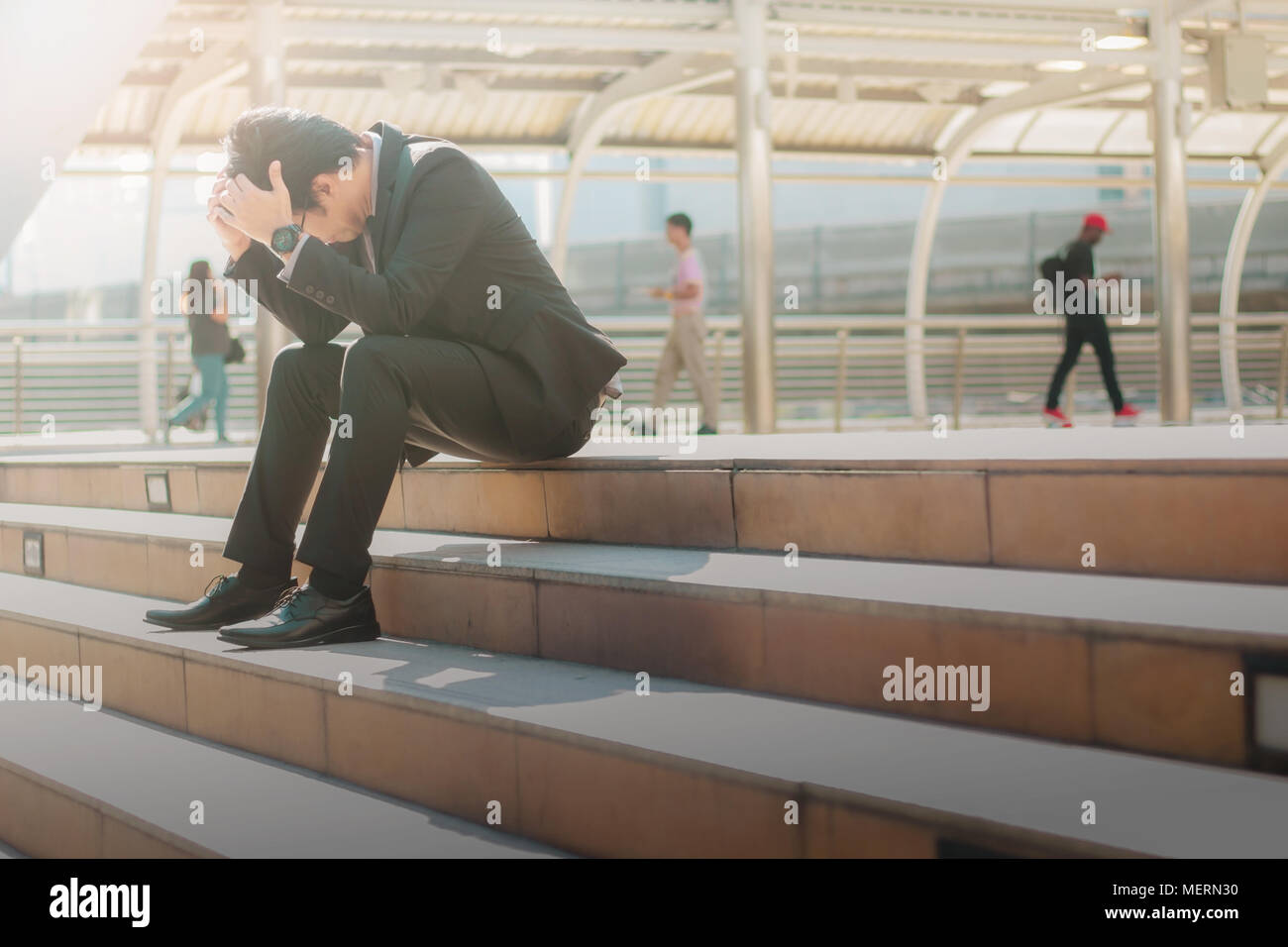 Sad businessman sitting on stairs hi-res stock photography and images ...