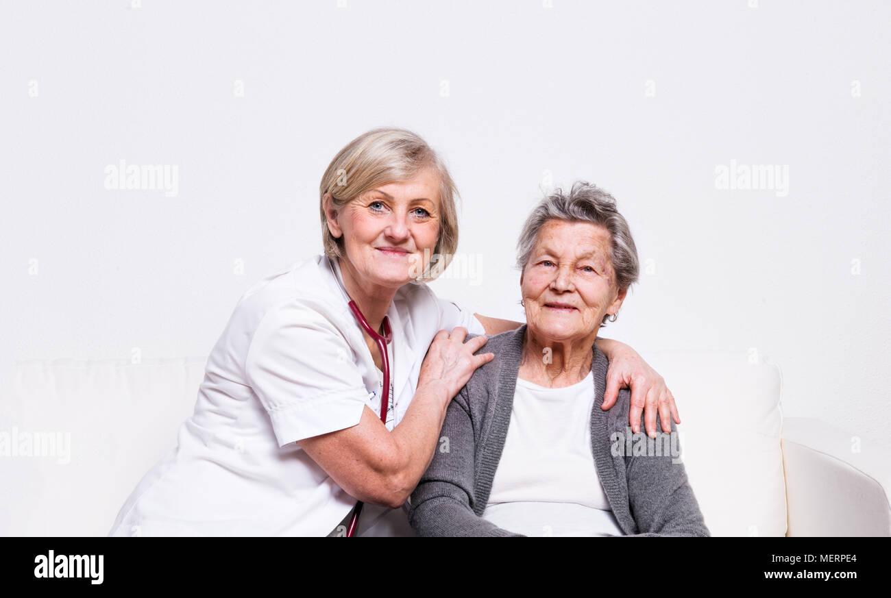 Studio portrait of a senior nurse and an elderly woman Stock Photo - Alamy