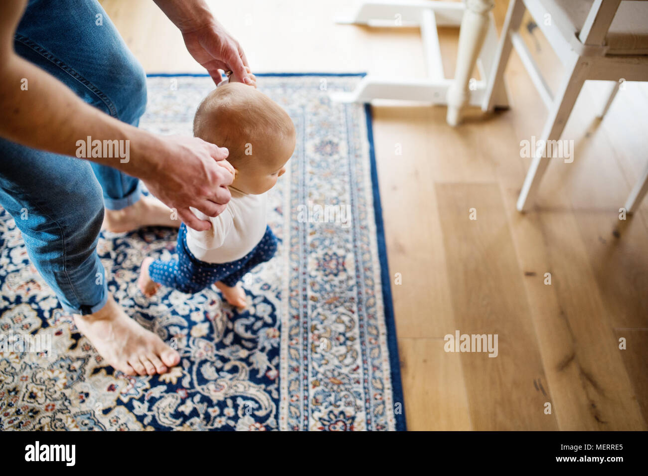 Father with a baby girl at home. First steps Stock Photo - Alamy