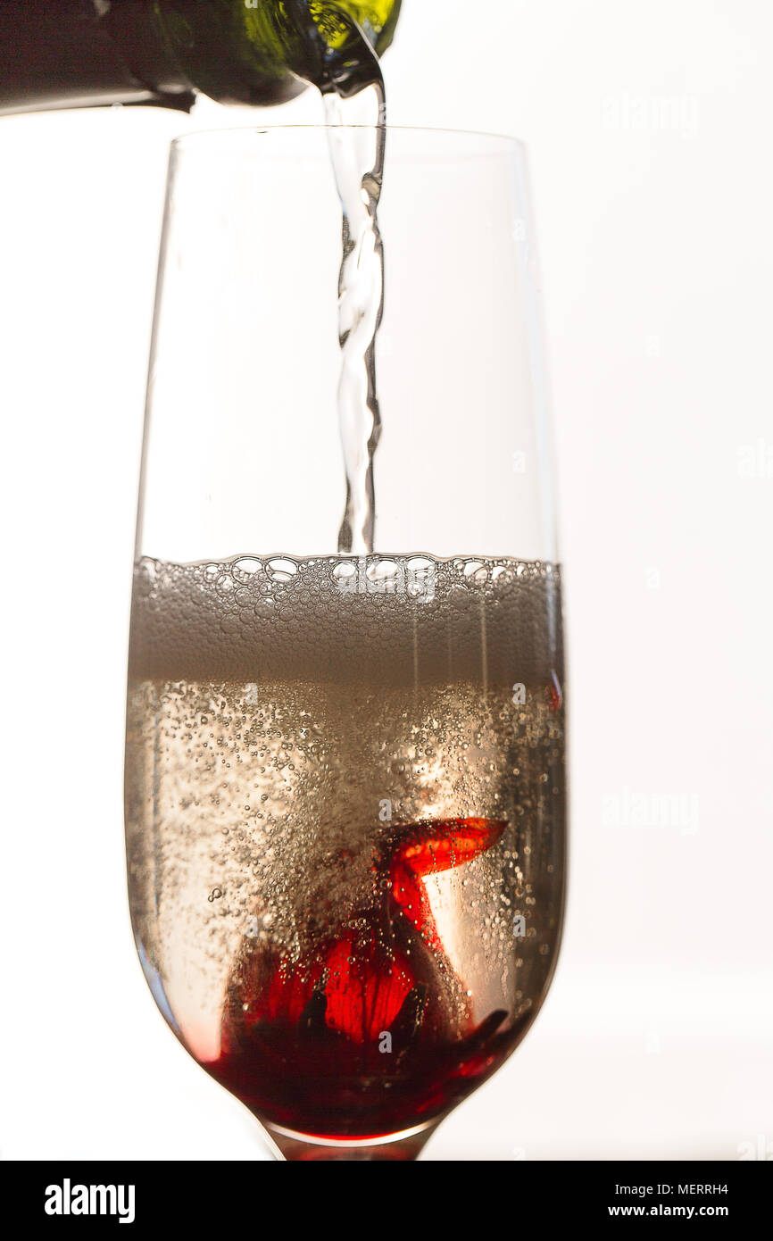 Pouring sparkling white wine over Hibiscus flower in glass Stock Photo ...
