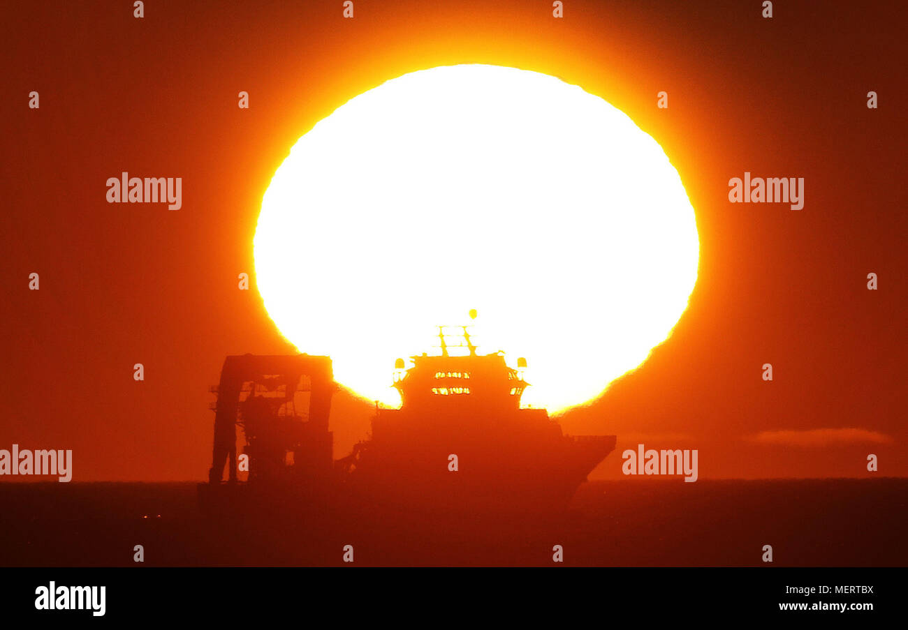 The offshore support vessel Havila Phoenix travels at sunrise across ...