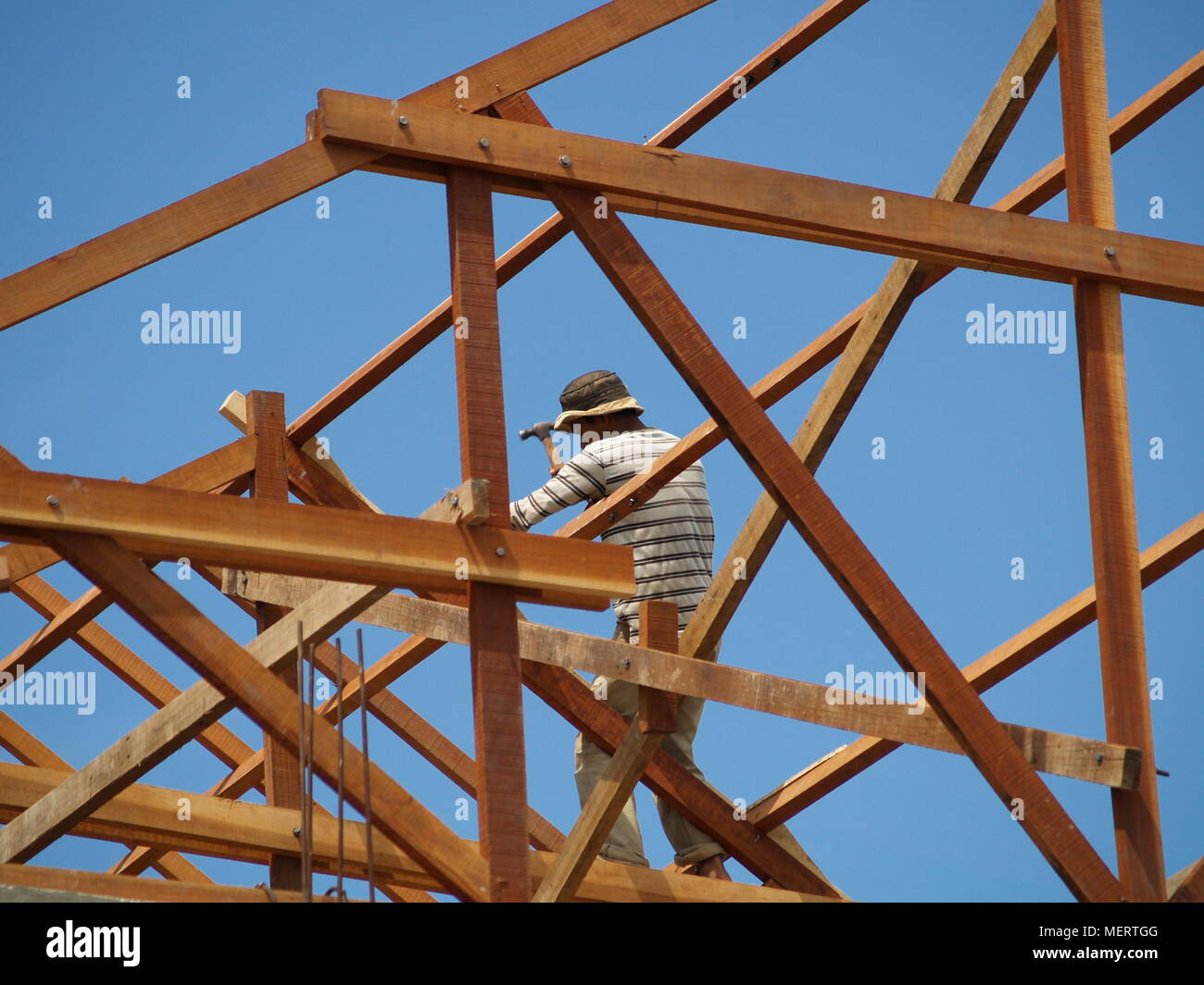 Roofer carpenter working on roof in Central city of Makassar Stock ...