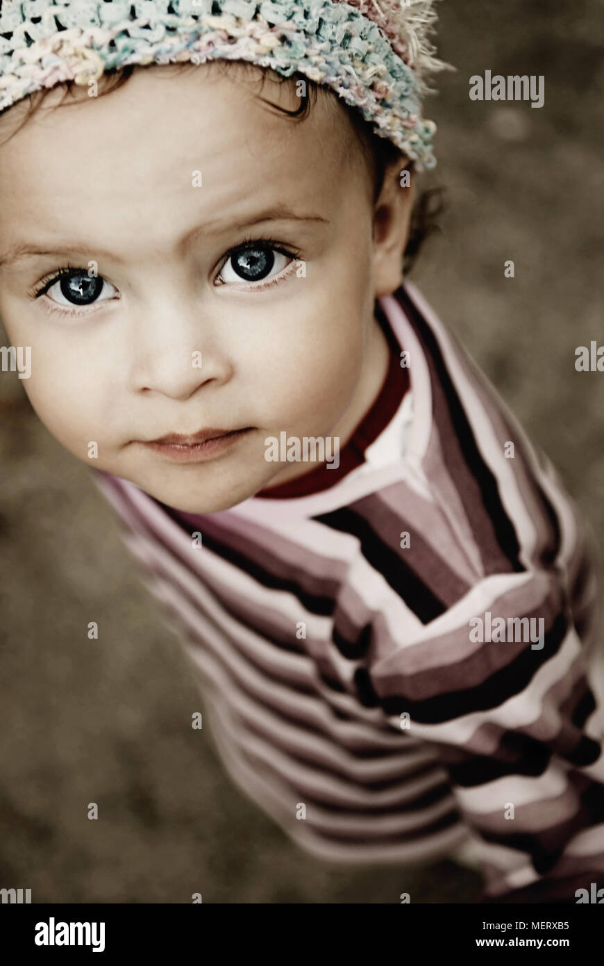 Portrait of a cute little girl, with an intense look in her eyes ...
