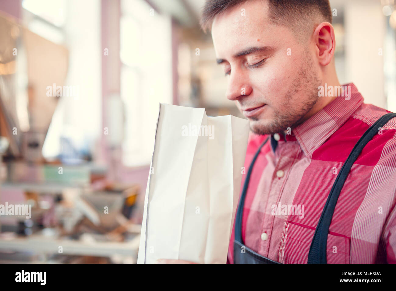 Picture of man sniffing coffee in paper bag Stock Photo - Alamy