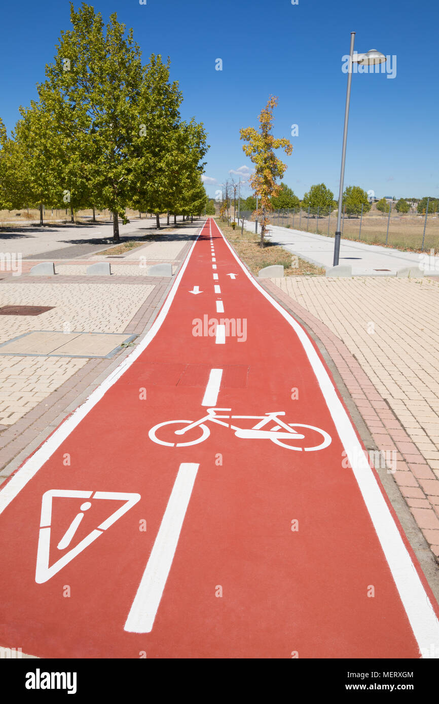 red bike double lane with painted white signs, cycle icon, warning ...