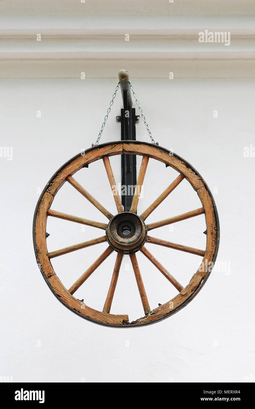 Old wheel hanging on the wall Stock Photo - Alamy