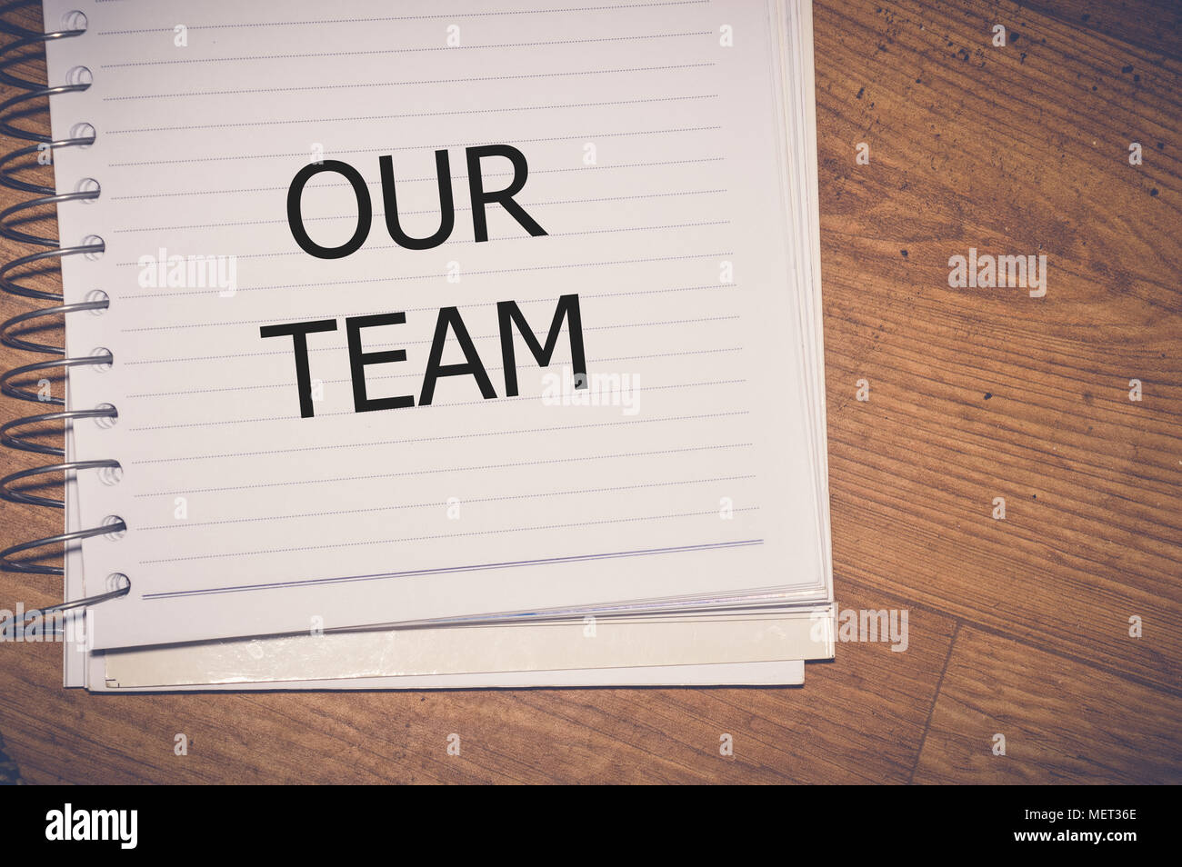 Our team word written on white paper Stock Photo - Alamy