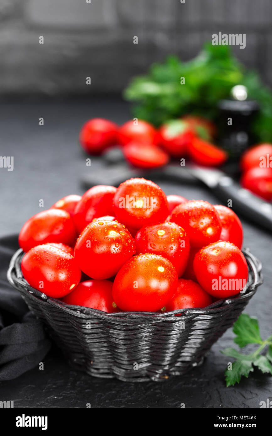 Tomatoes. Fresh tomatoes in basket on table Stock Photo - Alamy