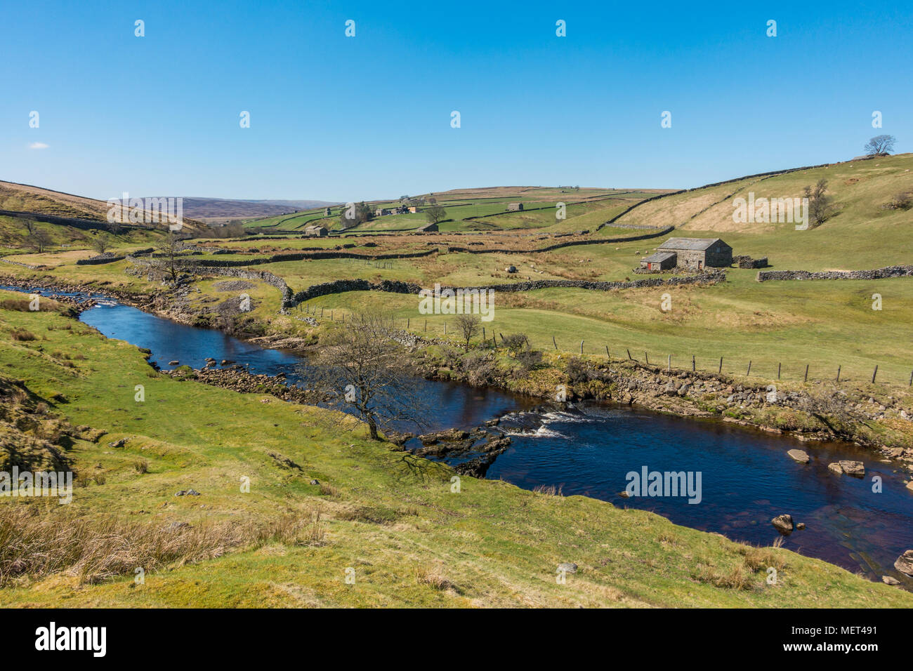 A picturesque view of Swaledale with the River Swale and the B6270 road ...