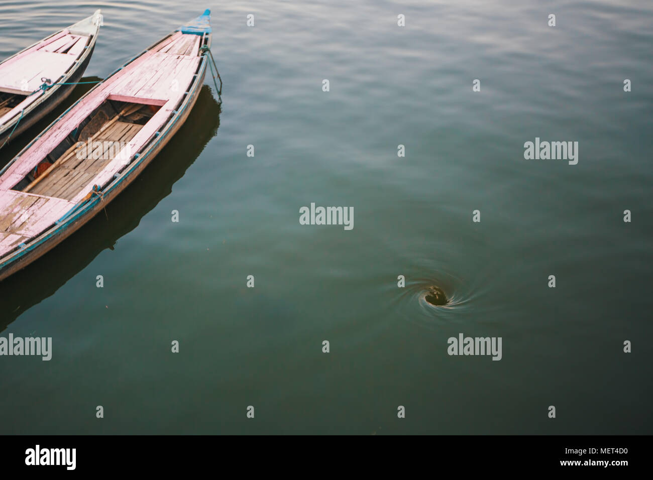 Funnel whirlpool in the water of the Ganges river in Varanasi, India ...