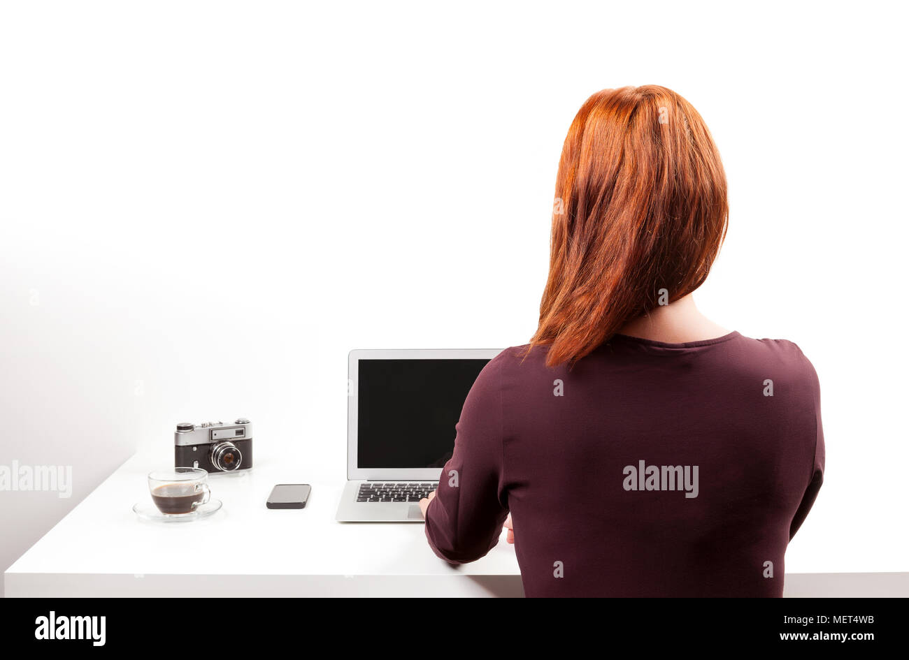 View from behind of a beautiful woman typing on a keyboard while ...