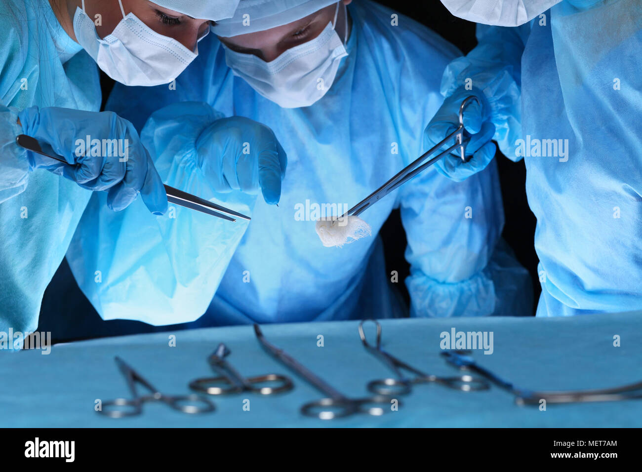 Group of surgeons in masks performing operation. Medicine, surgery and ...