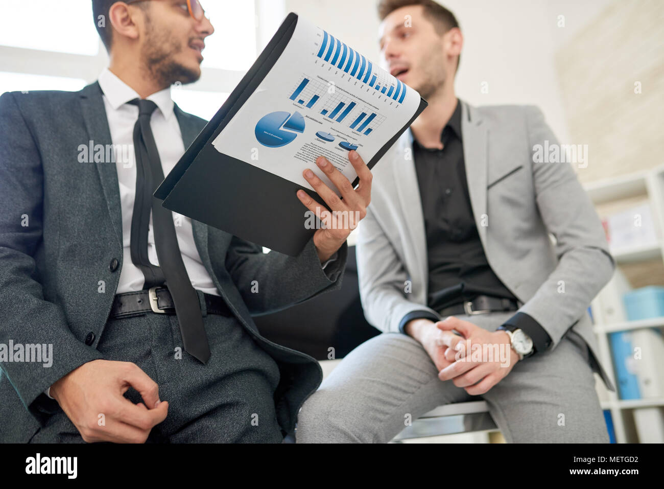 Discussing Statistics with Colleague Stock Photo - Alamy