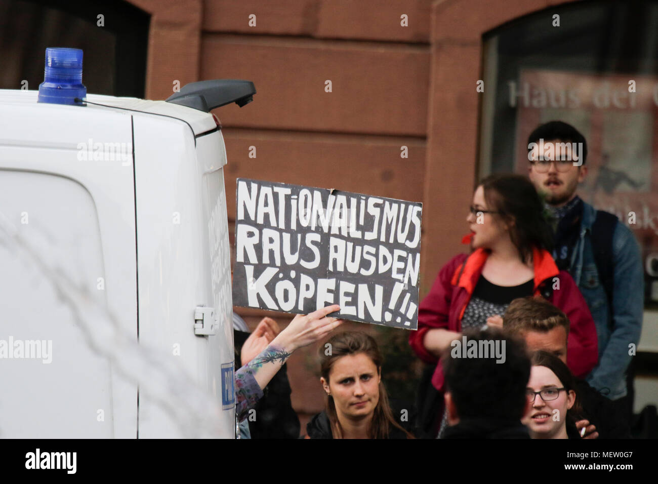 Mainz, Germany. 23rd April 2018. A counter-protester holds signs that ...