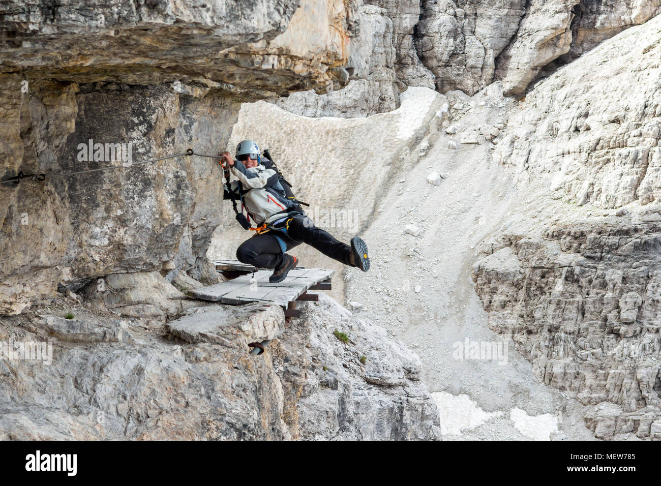 Female climber having some fun on dangerously narrow ledge with via ...