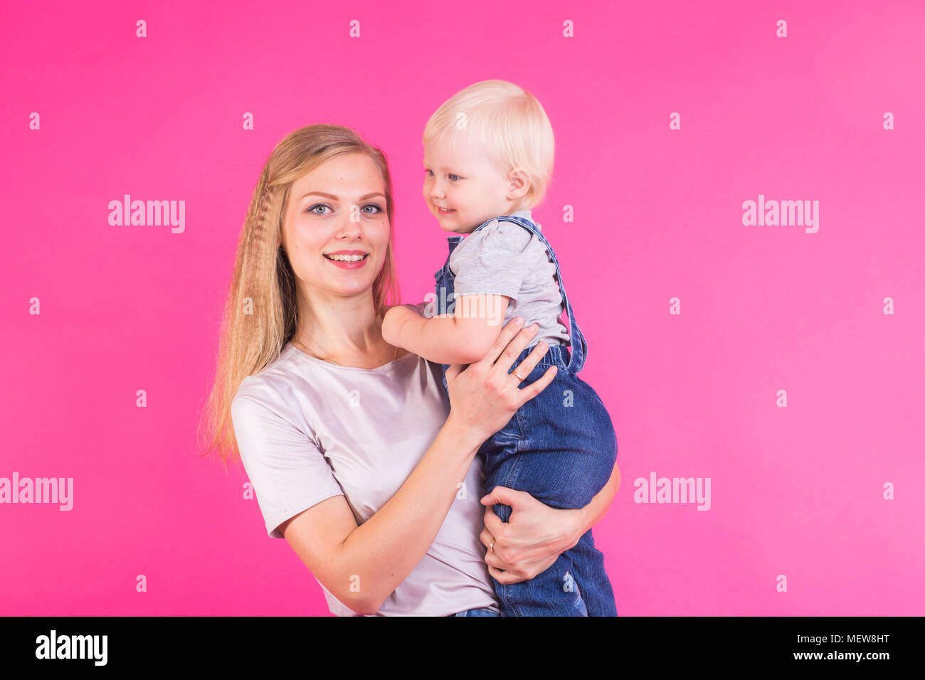 Young Mother And Daughter Having Fun Together On Pink Background Stock