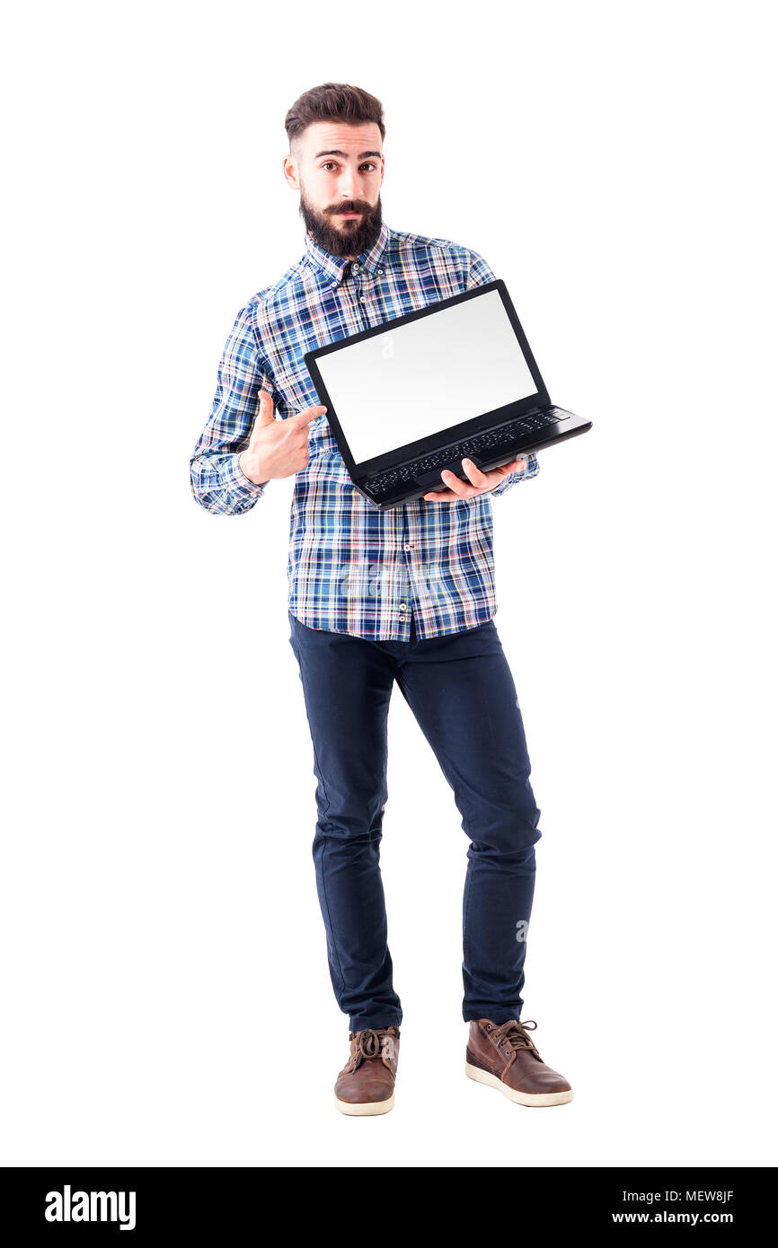 Stylish bearded young man pointing finger on blank laptop screen ...