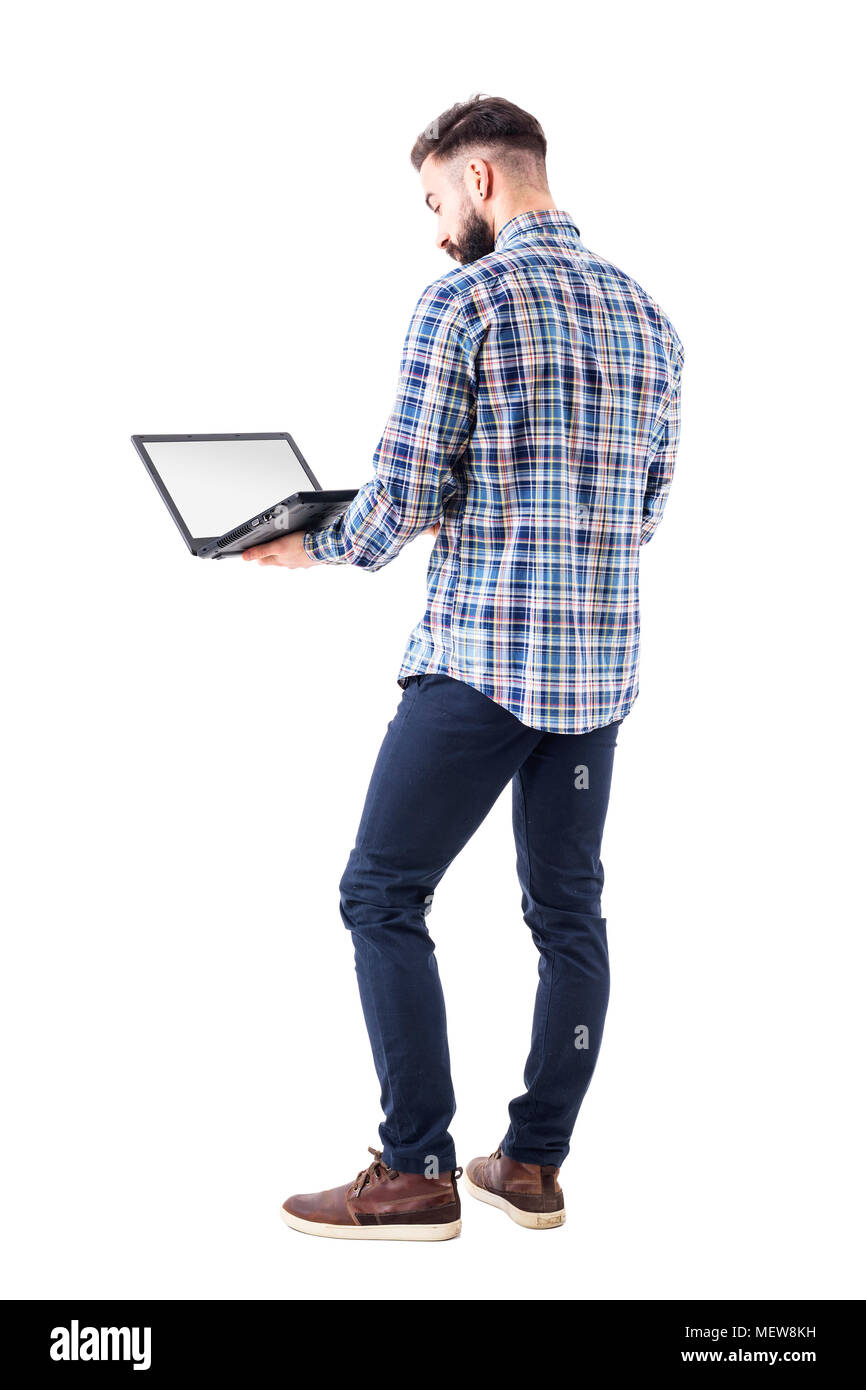 Standing professional business man holding and using laptop computer ...