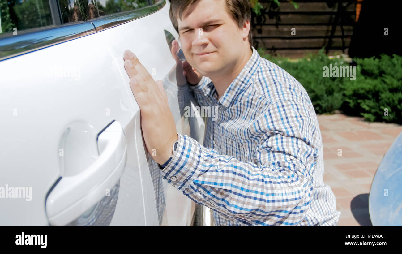Handsome customer checking car hi-res stock photography and images - Alamy