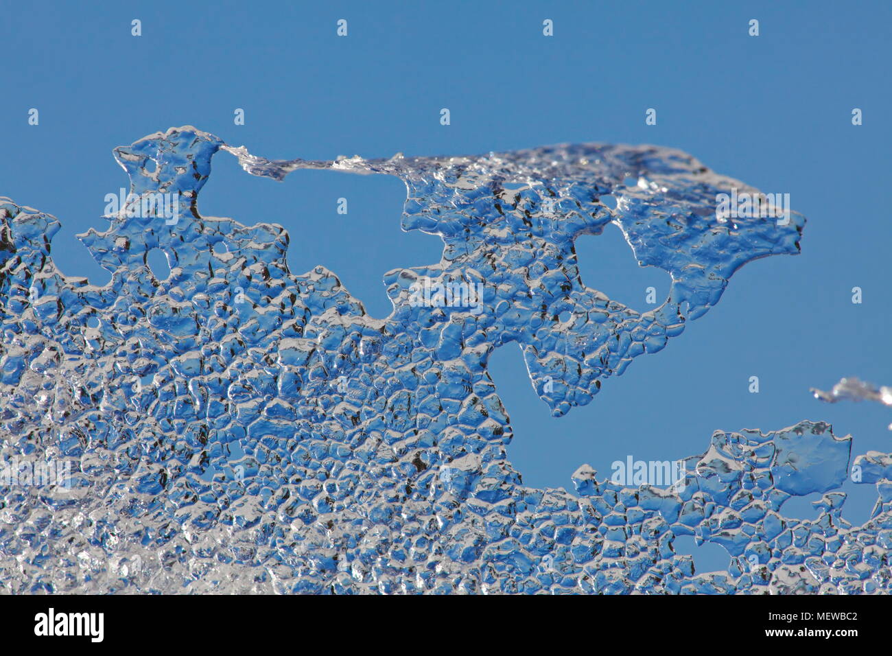 Close up of snow that has melted in the spring sunshine until only a ...