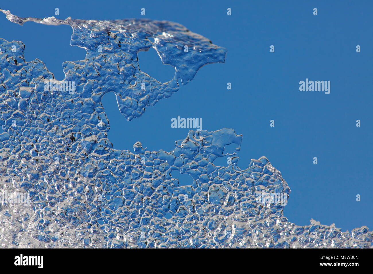 Close up of snow that has melted in the spring sunshine until only a ...