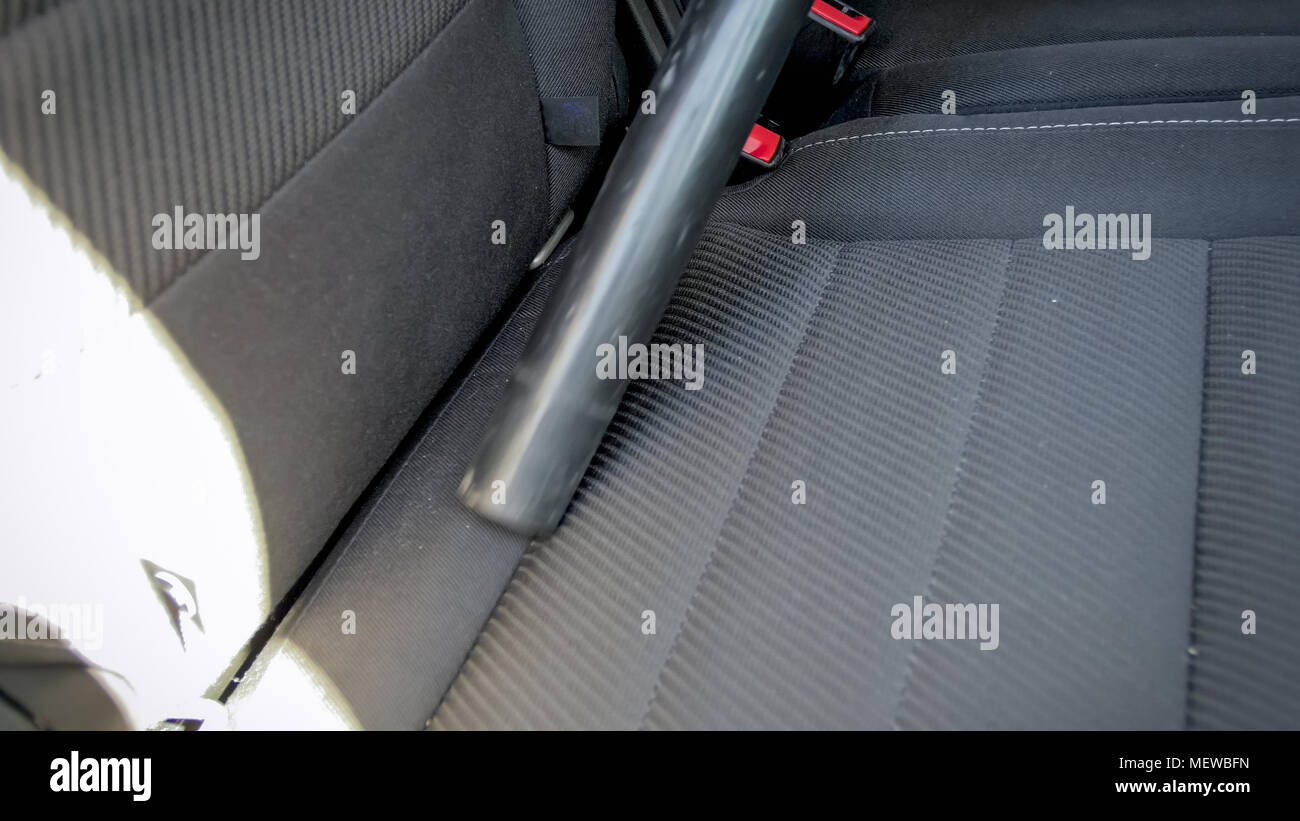 Closeup photo of cleaning dust from car back seat with vacuum cleaner ...