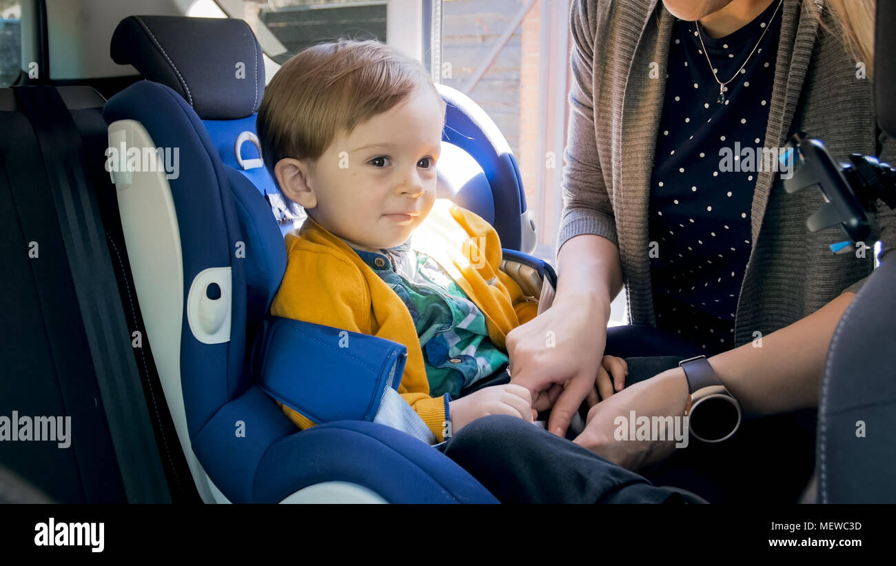Adorable smiling toddler boy sitting in car safety seat Stock Photo - Alamy