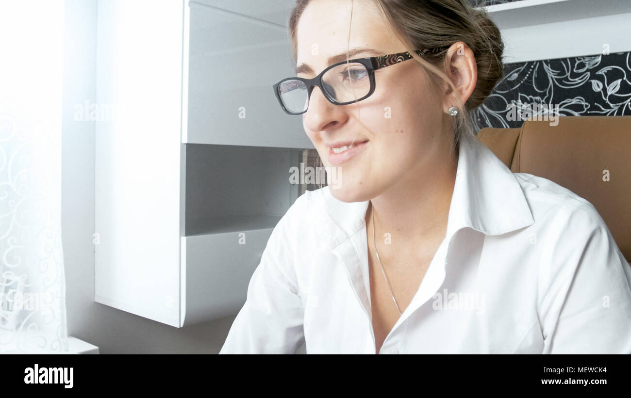Closeup portrait of young smiling businesswoman wearing eyeglasses ...