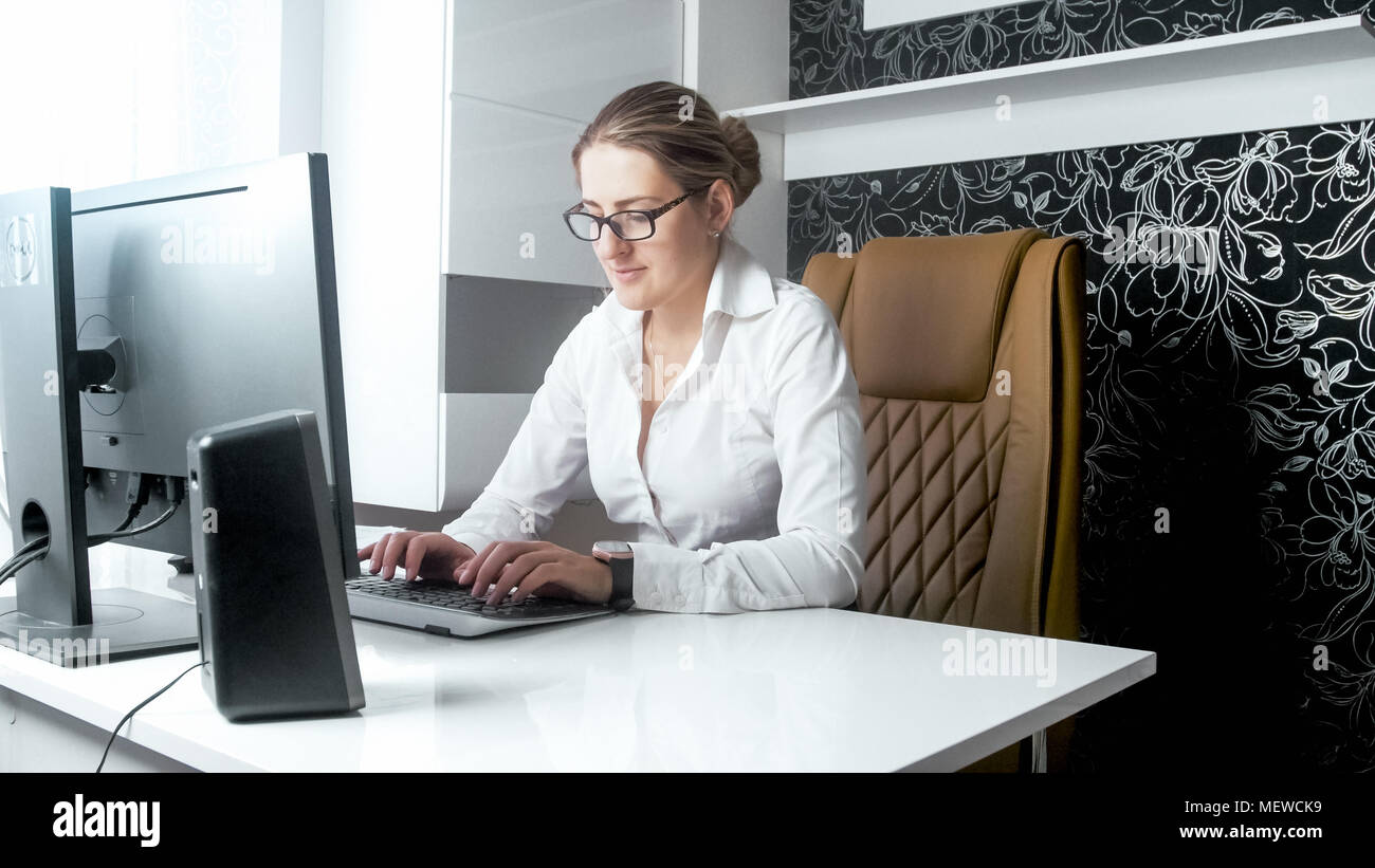 Beautiful female boss working in her personal office Stock Photo - Alamy