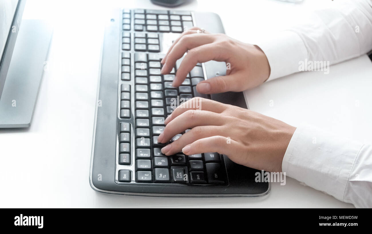 Closeup photo of female fingers pressing buttons on computer leyboard ...