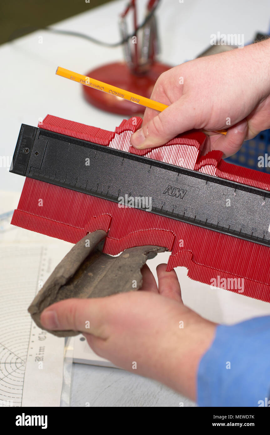 An Archaeologist making impression to enable accurate drawing of the ...