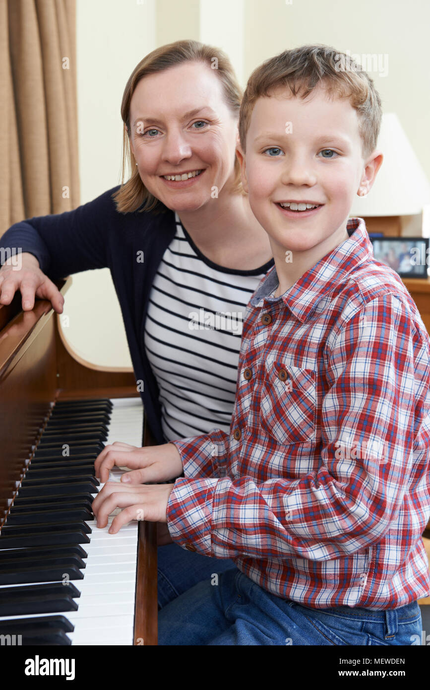 Portrait Of Boy With Music Teacher Having Lesson At Piano Stock Photo ...